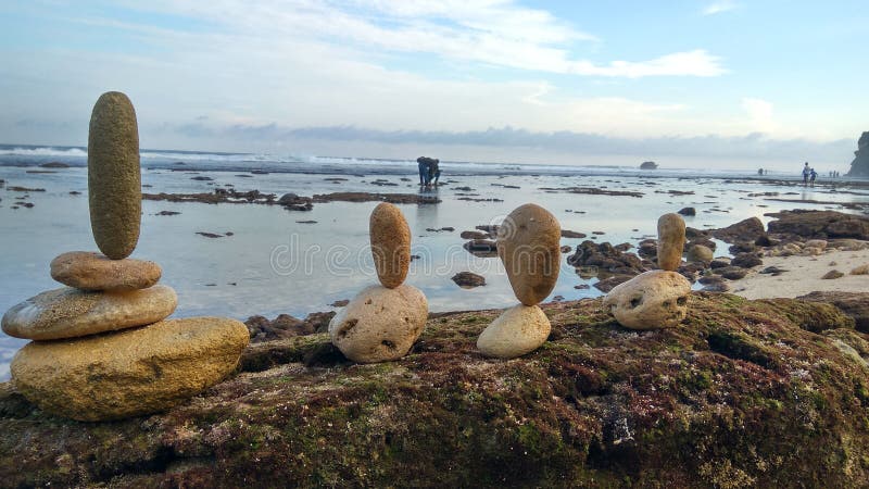Pile of rocks in the sea stock photo. Image of wave - 264178424