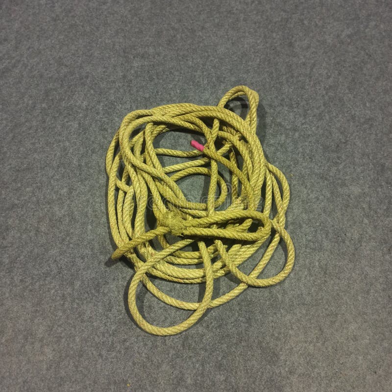 A Pile of Rope, Its Strands Intertwined, Sits on a Gray Backdrop. Stock ...