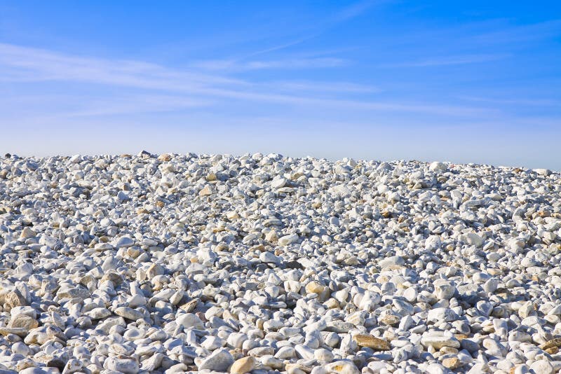 Pile of Rounded White Stones Against a Blue Sky Stock Image - Image of ...