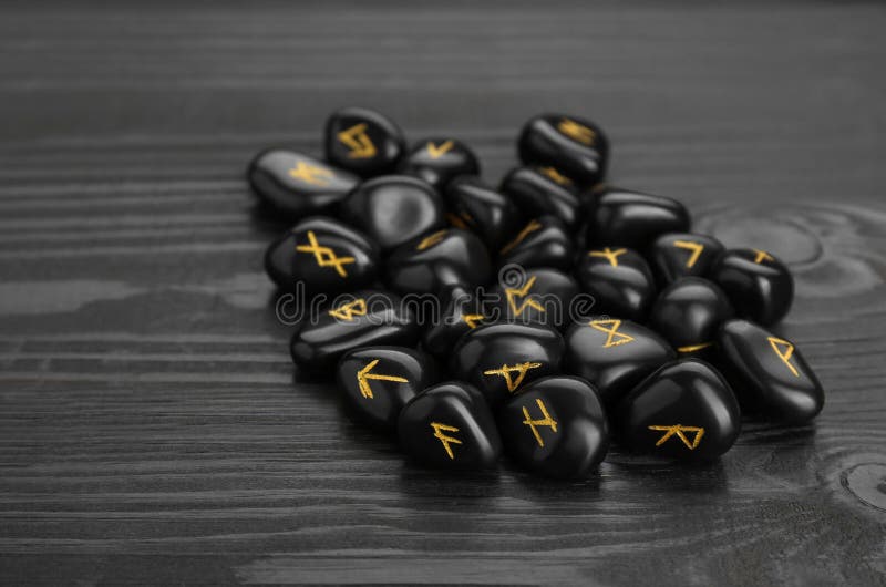 Pile of Rune Stones on Black Wooden Table Stock Photo - Image of celtic ...