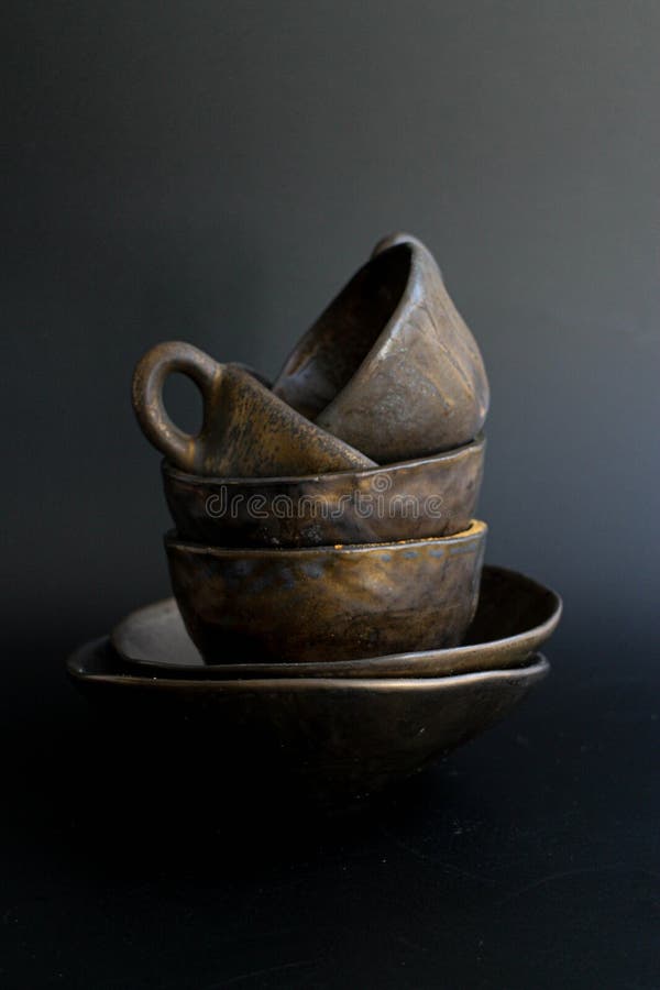 A Pile of Rustic Tea Cup on Black Background Stock Image - Image of ...