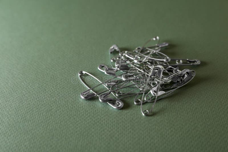 Pile of Safety Pins on Green Background, Space for Text Stock Image ...