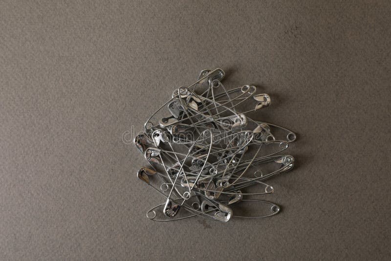 Pile of Safety Pins on Grey Textured Background, Flat Lay Stock Photo ...