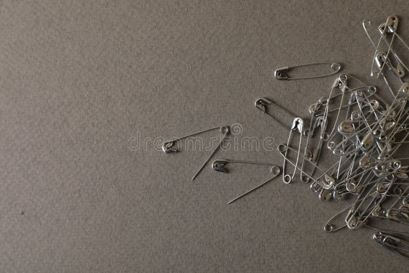 Pile of Safety Pins on Grey Textured Background, Flat Lay. Space for ...