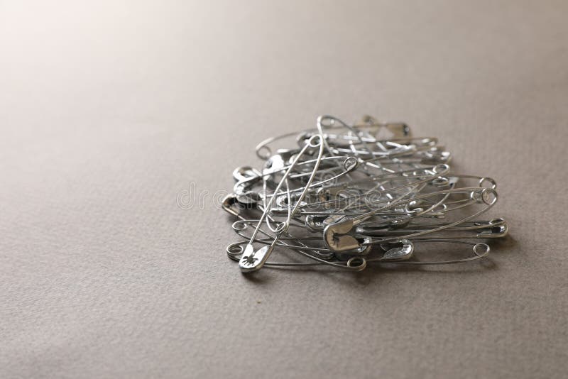 Pile of Safety Pins on Light Grey Textured Background, Space for Text ...