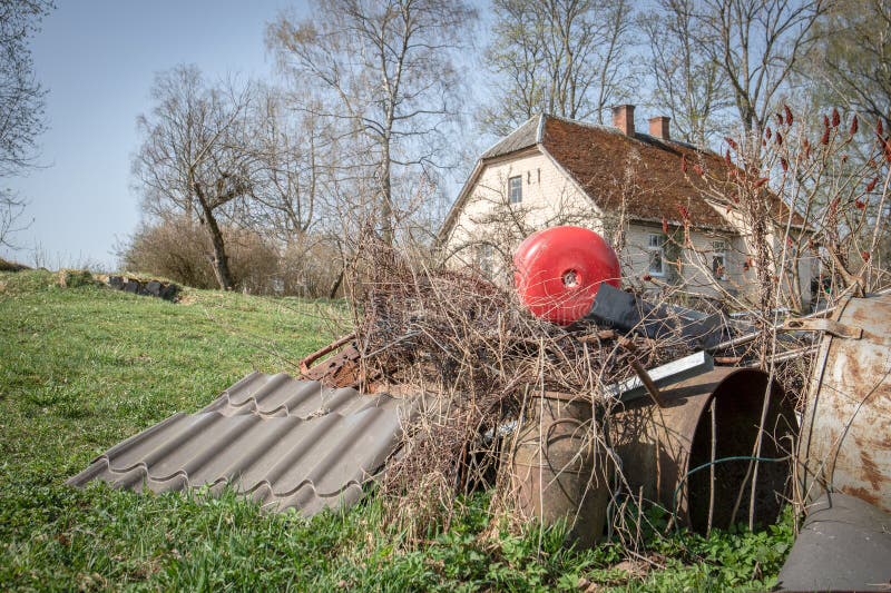 Pile of Scrap Metal and Old Materials in Front of Rural House Stock ...