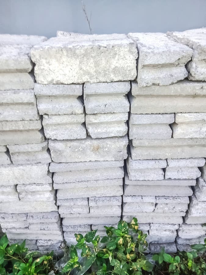A Pile of Several Bricks Arranged Neatly Next To the Wall Stock Image ...