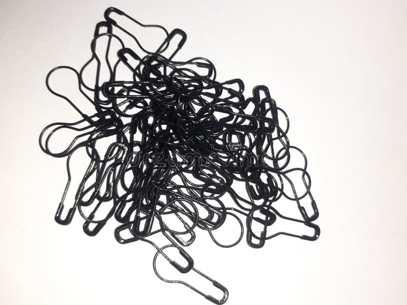 A Pile of Small Black Pins in the Shape of a Bulb, on a White ...