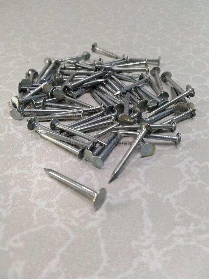 A Pile of Small Concrete Nails Can Be Seen on the White Table Stock ...