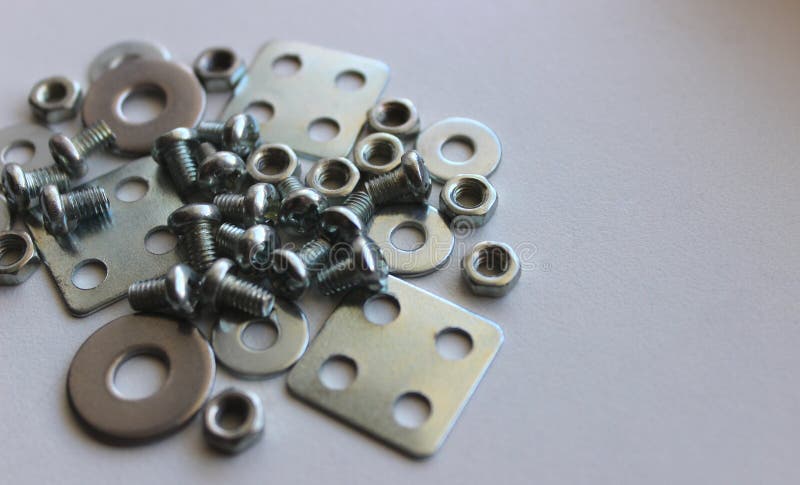 Pile of Small Hardware on Clean White Surface at a Side of Image Stock ...