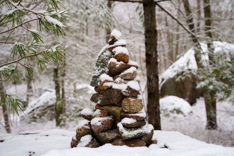 Pile of Stones Stacked As a Pyramid, Covered by Snow in a Forest Stock ...