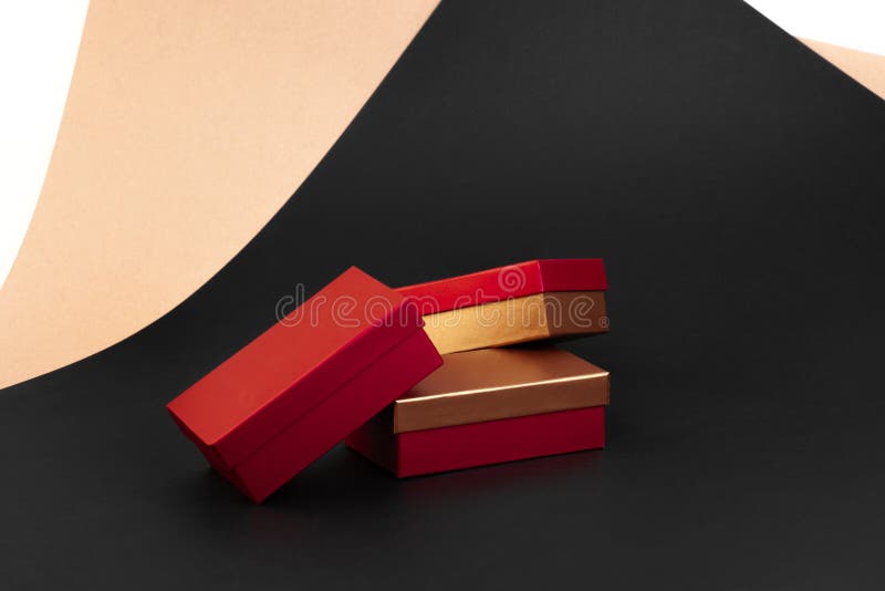 A Pile of Three Golden-red Boxes on a Background of Beige, Black, White ...