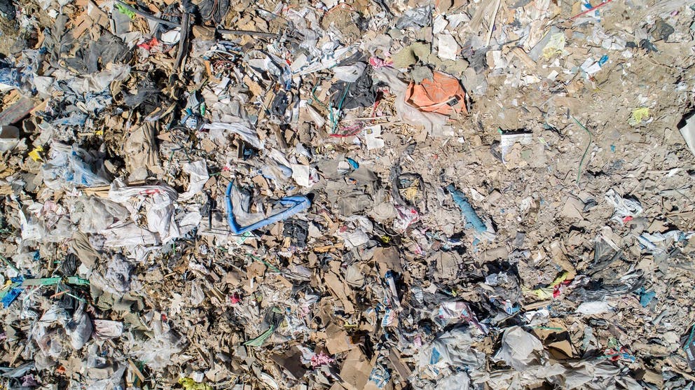A Pile of Trash with a Blue Object in the Middle Stock Photo - Image of ...