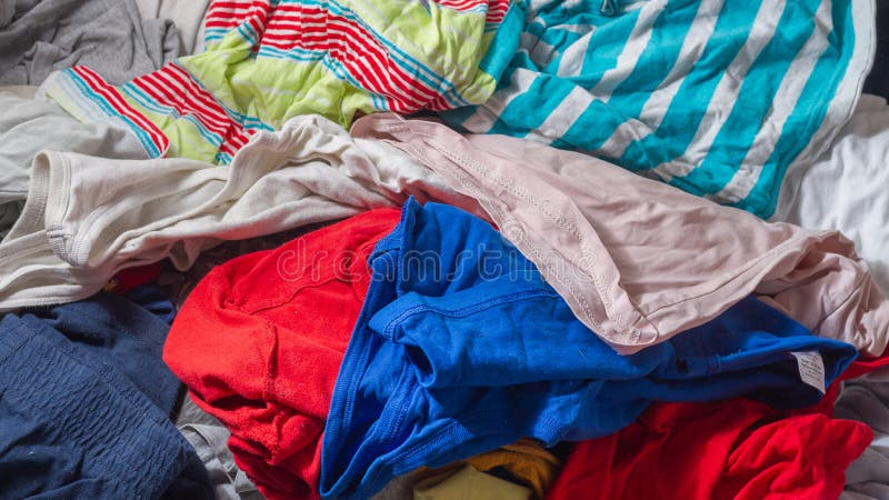 A Pile of Un-ironed Clothes of Various Colors Lies on the Floor Stock ...