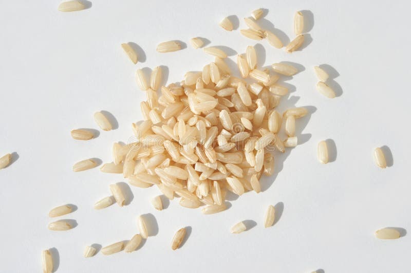 Pile of Uncooked Brown Rice on White Background with Scattered Grains ...
