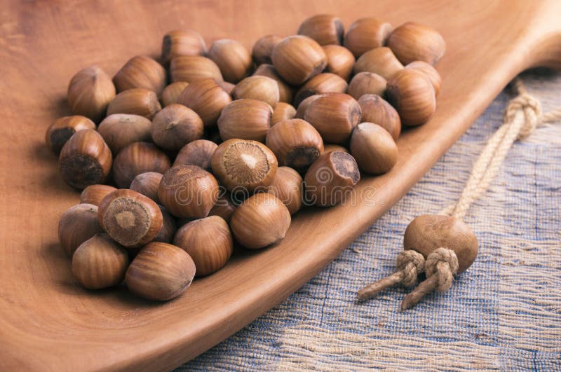 A Pile of Unshelled Hazelnuts on a Wooden Tray Stock Image - Image of ...