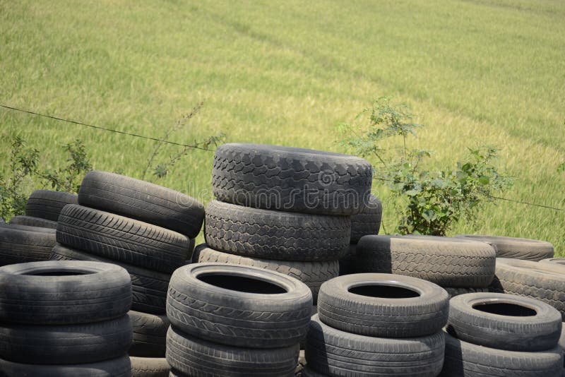 Pile of Used Tires Near the Rice Fields. Stock Photo - Image of field ...