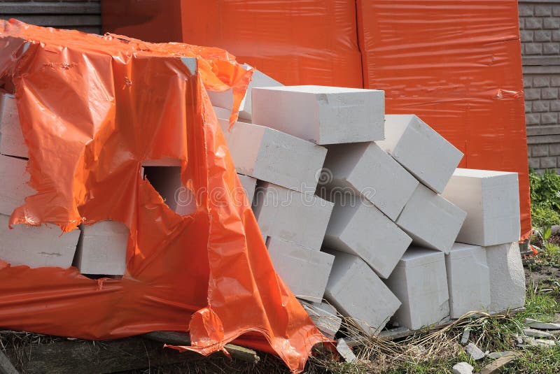 A Pile of White Bricks and Foam Blocks in Red Plastic Cellophane ...