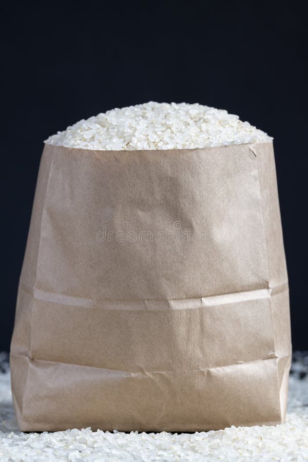 A Pile of White Rice in a Paper Bag and on the Table Stock Photo ...