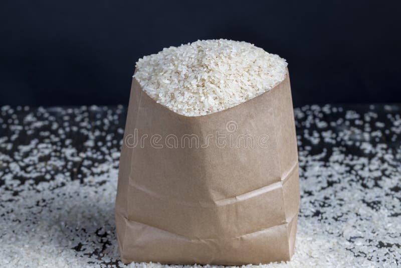 A Pile of White Rice in a Paper Bag and on the Table Stock Photo ...