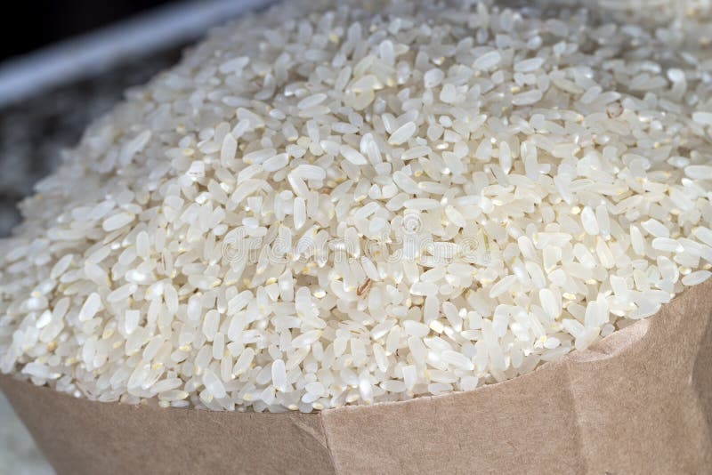 A Pile of White Rice in a Paper Bag and on the Table Stock Photo ...