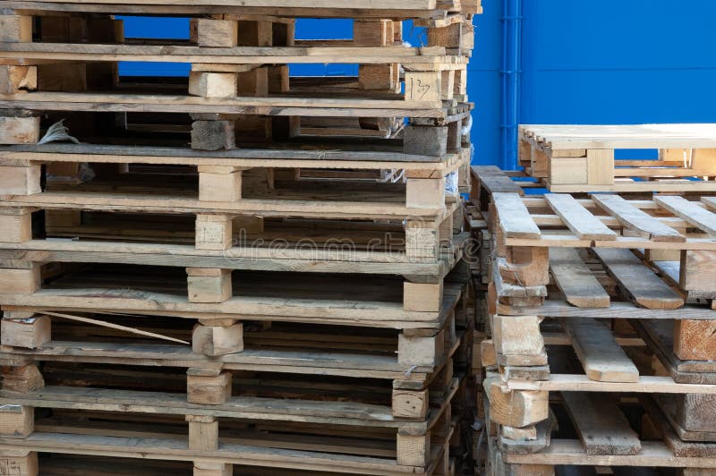 Pile of Wooden Pallets Against the Blue Wall Stock Photo - Image of ...