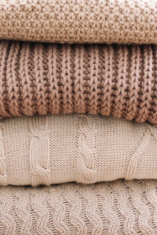 Pile of Woolen Plaids on a Light Background. Stack of Knitted Clothes ...
