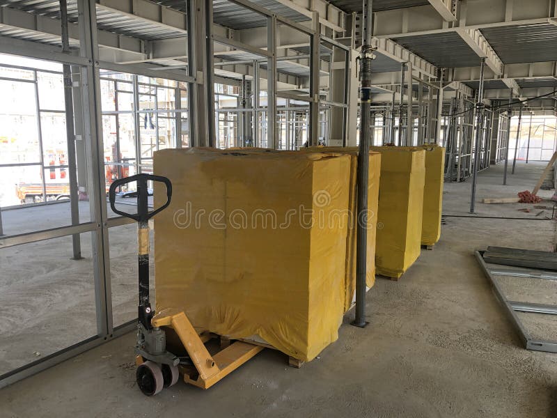 Piled Cinder Blocks Wrapped in Yellow Packaging on the Floor of the Prefabricated Multi-storey ...