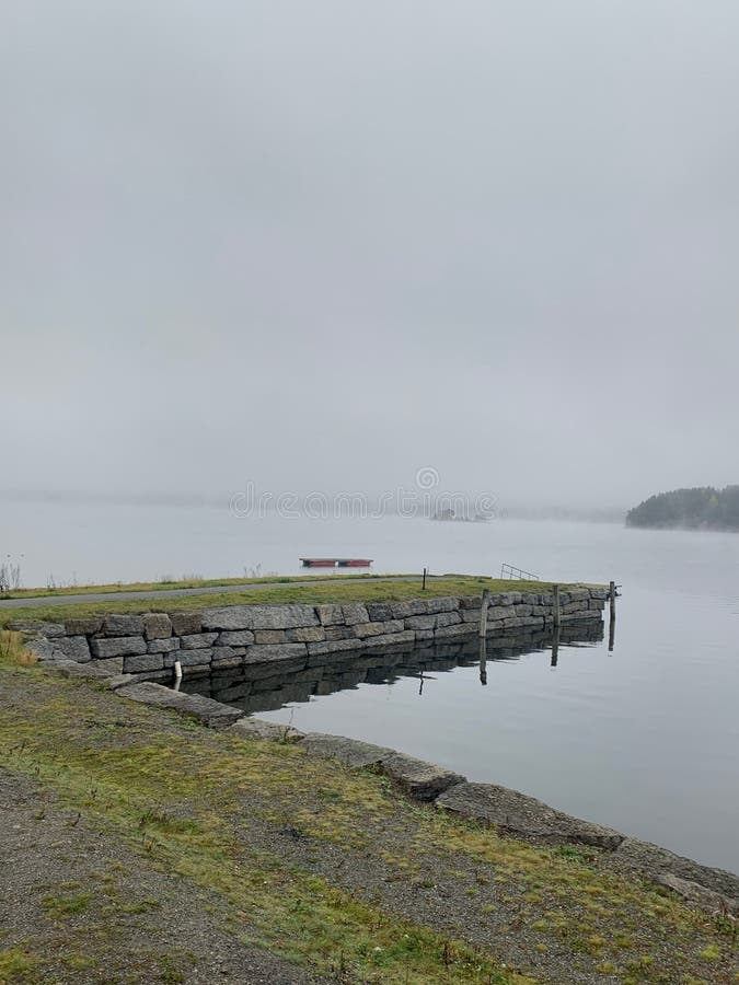 Piled Stone Dock and Calm Lake on a Foggy Day Stock Photo - Image of ...