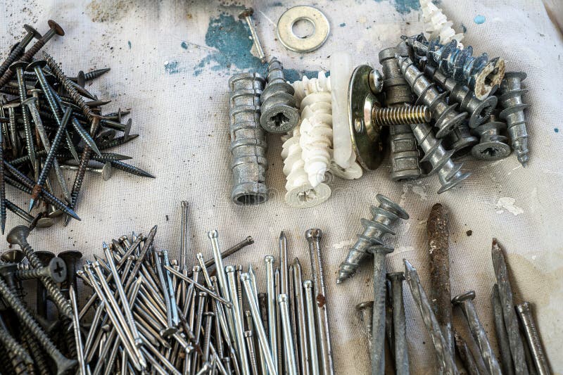 Piles of Anchors Srews Nails and Different Hardware on a Drop Sheet ...
