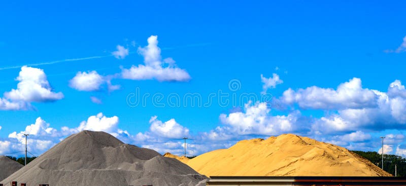 Piles of Gravel and Sand on a Construction Site Under a Bright Blue Sky ...