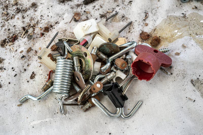 Piles of Keys Springs Hooks and Different Hardware on a Drop Sheet ...