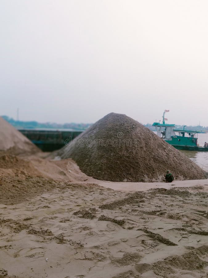 Piles of Sand Piled Up Along the Riverbank Stock Photo - Image of piles ...