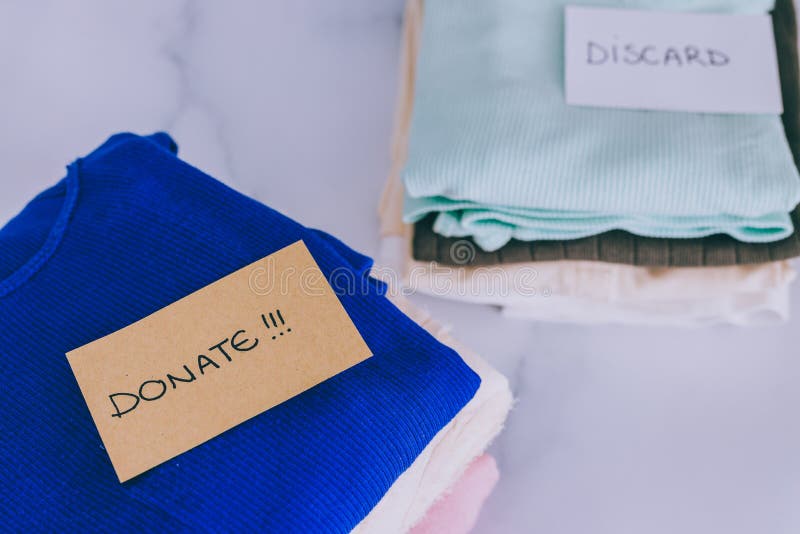 Piles of Tshirts and Clothes Being Sorted into Keep Discard and Donate ...