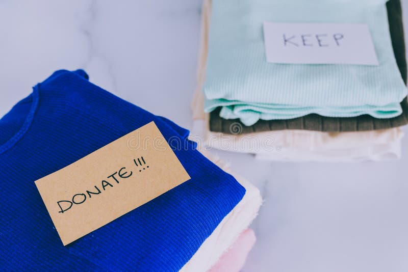 Piles of Tshirts and Clothes Being Sorted into Keep Discard and Donate ...