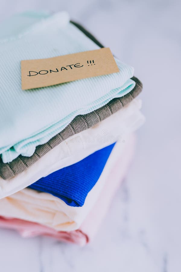 Piles of Tshirts and Clothes Being Sorted into Keep Discard and Donate ...
