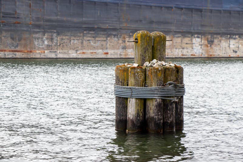 Piling and a Ship in the Harbour Stock Photo - Image of lakes, spring ...