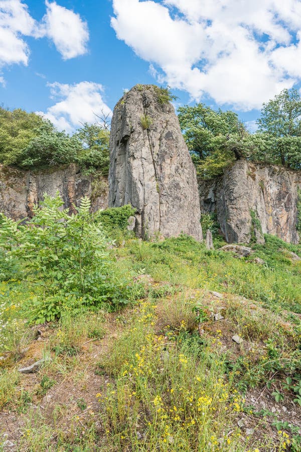 A Pillar in Front of a Rock Face. Stock Photo - Image of copse, nature ...