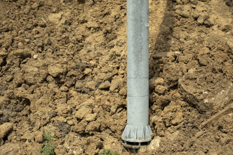 A Pillar in the Ground. Dug Up the Ground Under the Metal Pillar Stock ...