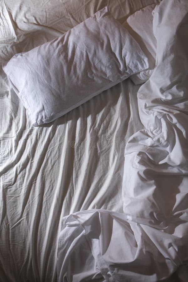 Pillow on a crumpled bed stock image. Image of bedsheet - 110261647