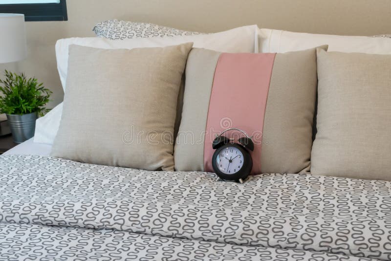 Pillows and Alarm Clock on Bed Stock Image - Image of room, fashioned ...
