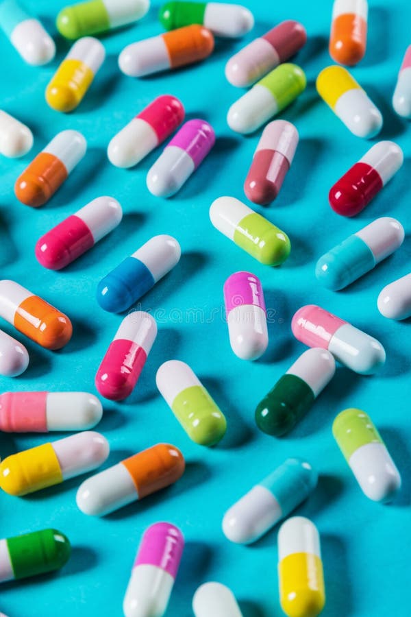 Pills of Different Colors on a Blue Background Pastel Stock Image ...