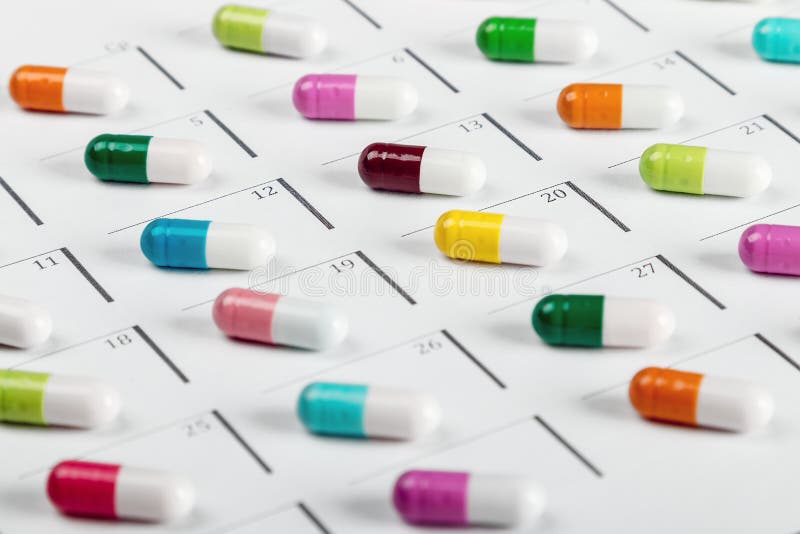 Pills of Different Colors on a Calendar Stock Photo - Image of ...