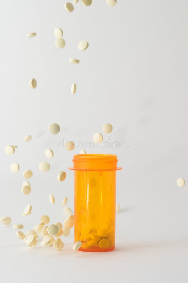 Pills Falling into and Around Medicine Bottle Stock Photo - Image of ...