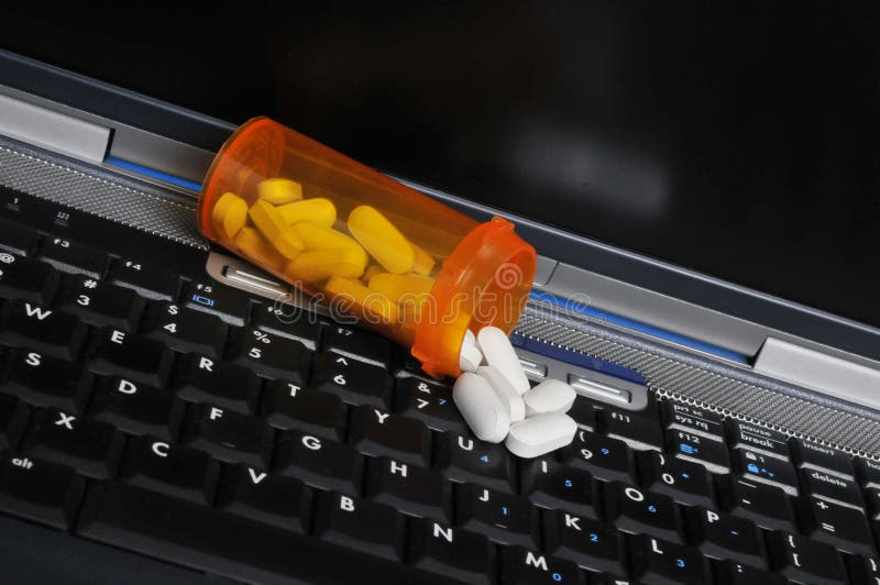 Pills on Laptop Computer stock image. Image of medical - 6598711