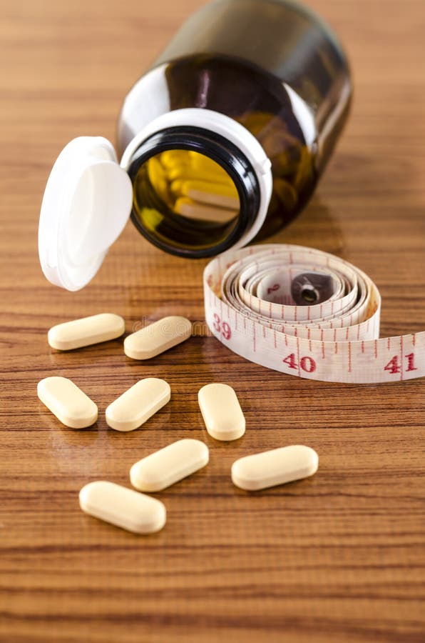 Pills and measuring tape stock photo. Image of figure - 41179212