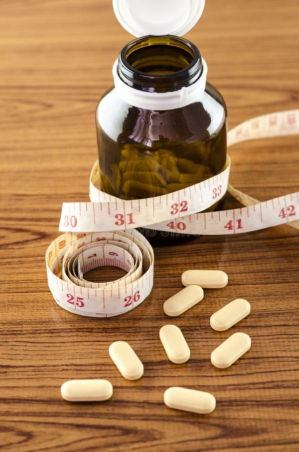 Pills and measuring tape stock photo. Image of medication - 41179386