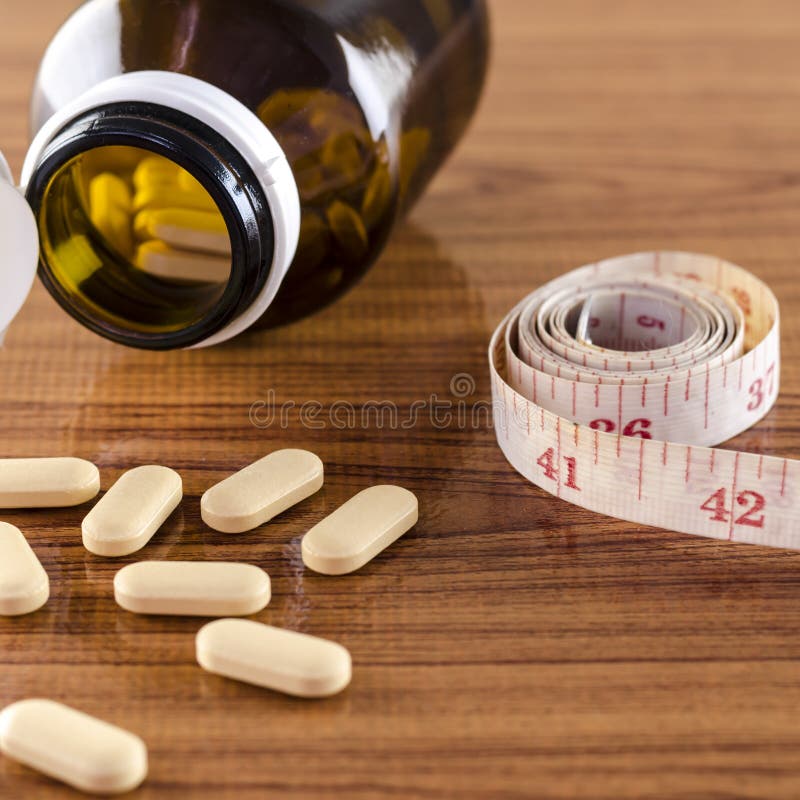 Pills and measuring tape stock photo. Image of drug, inches - 41199452