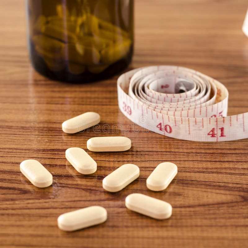 Pills and measuring tape stock image. Image of drugs - 41199499