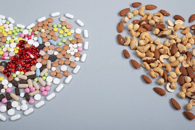 Pills and Nuts Different Types in the Shape of Heart. Healthy Concept ...